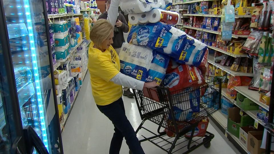 Local volunteer races to fill cart for those in need during shopping spree