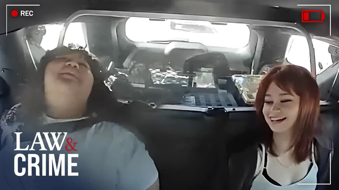 Giggling teen girls joke in cop car after murder plot arrests