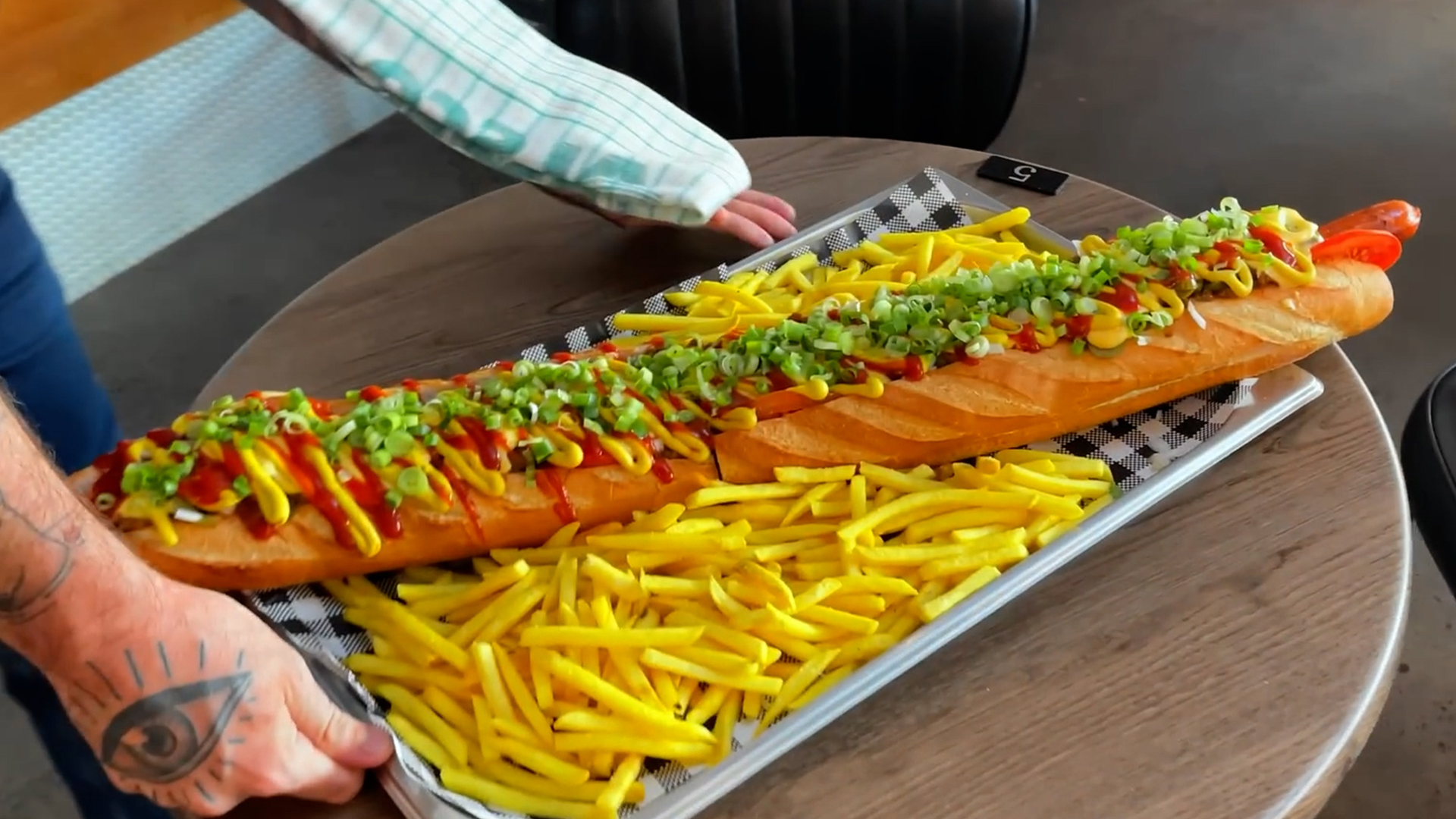 Pro eater takes on 3kg loaded hot dog challenge