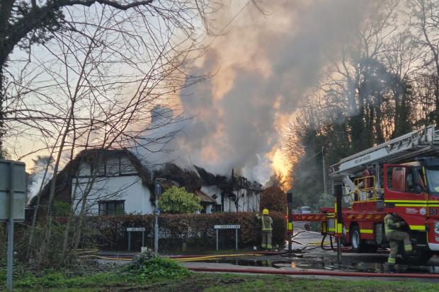 Photos: 60 firefighters tackle large thatched roof house fire