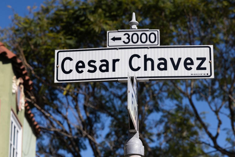 Cesar Chavez statue covered in black tarps and plastic bags at Fresno State