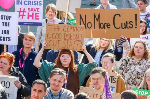 Huge crowds gather outside university in fierce protest over plans to ...