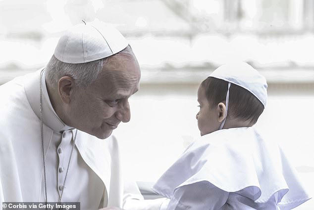 Pope Leo blesses baby who is dressed like him