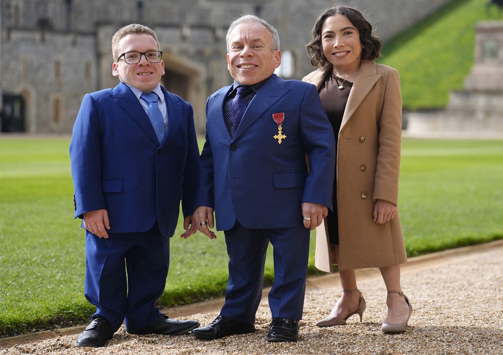 Warwick Davis celebrates OBE with his two children – and mystery companion