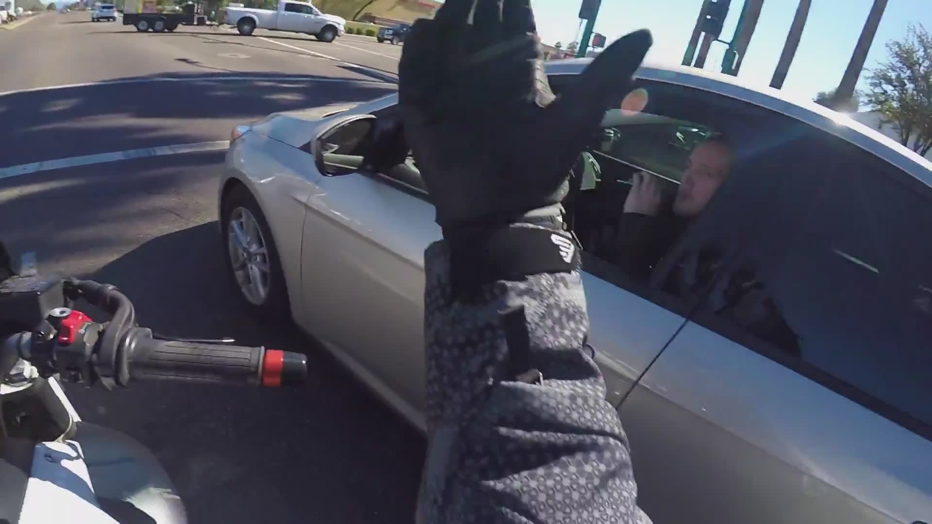 Random driver rolls down the window to offer a cigarette to the biker ...