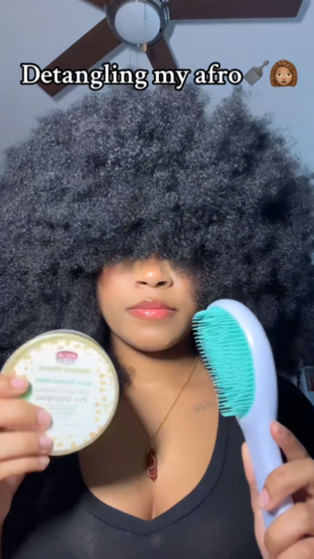 Detangling afro hair before wash day