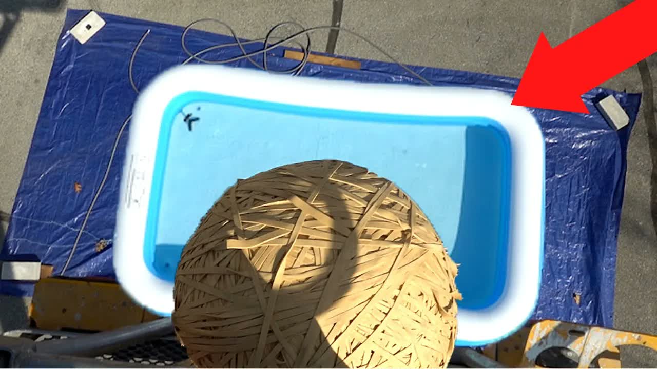 160-pound rubber band ball dropped 40 feet into a pool