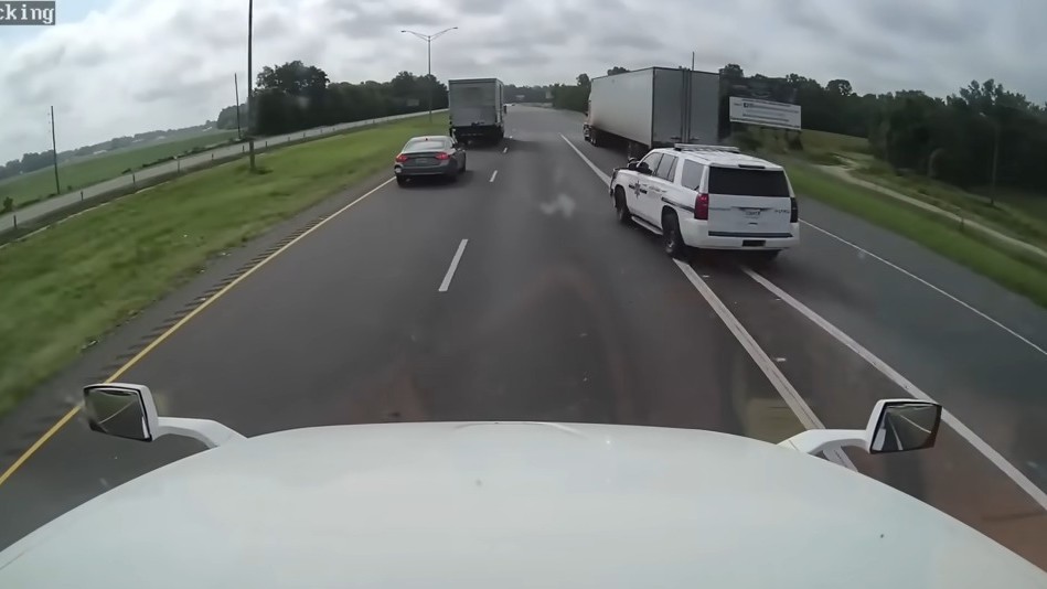 A police vehicle cuts off a truck and proves arrogance can wear a uniform