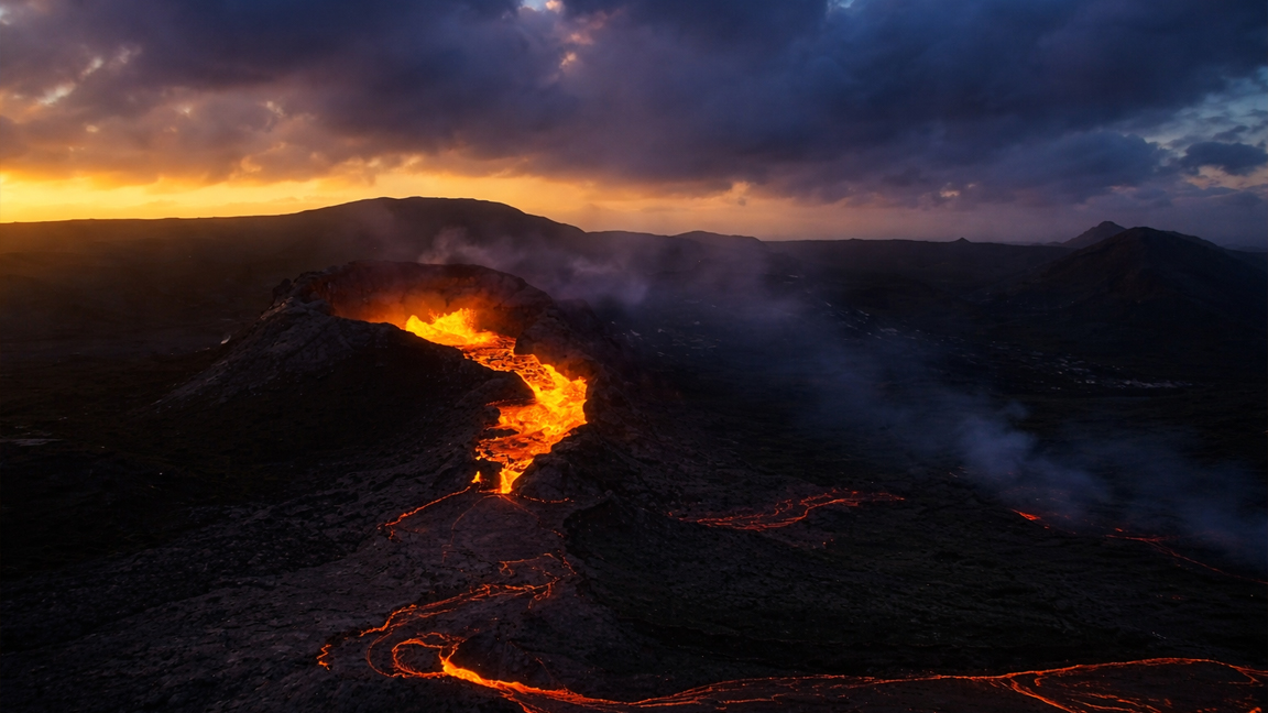 A dramatic volcano eruption under a dark sky