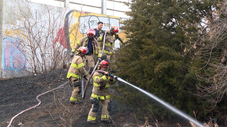 Omaha Fire Department battles field fire near train tracks