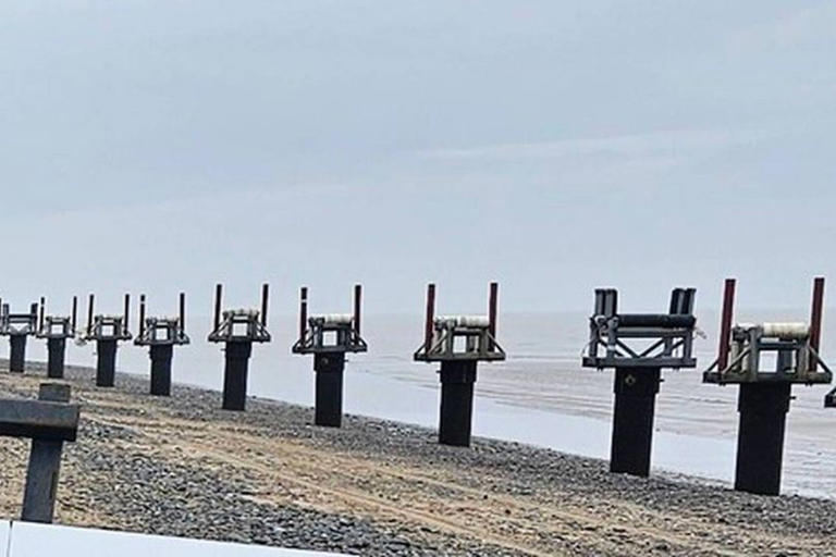 Strange steel structures appear lined up on UK beach with 'danger' signs