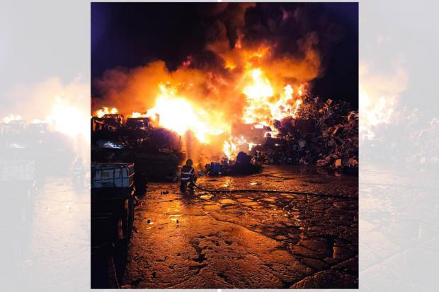 Road closed as firefighters remain on scene of large scrap metal fire