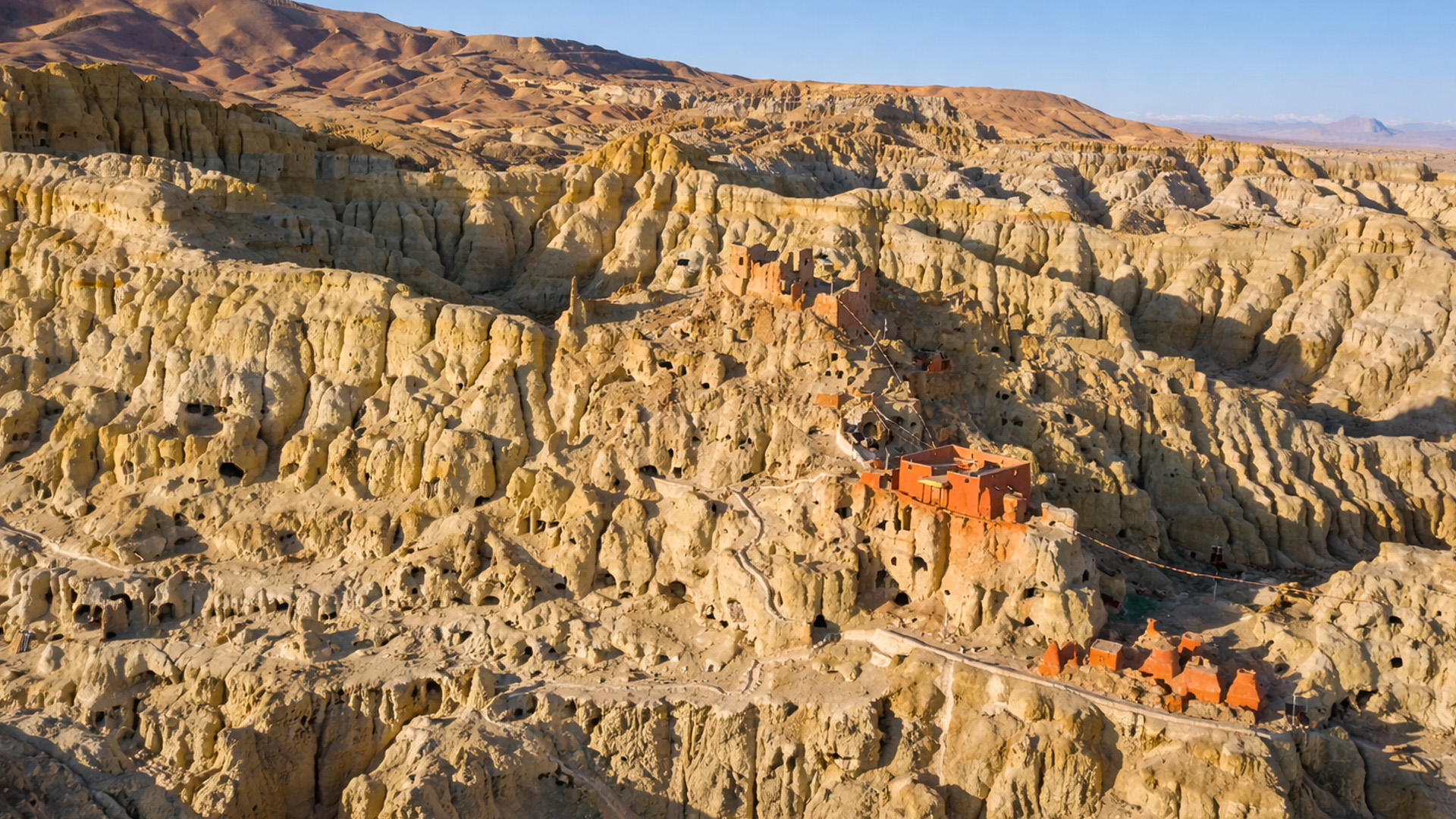 A monastery built directly into a mountain cliff