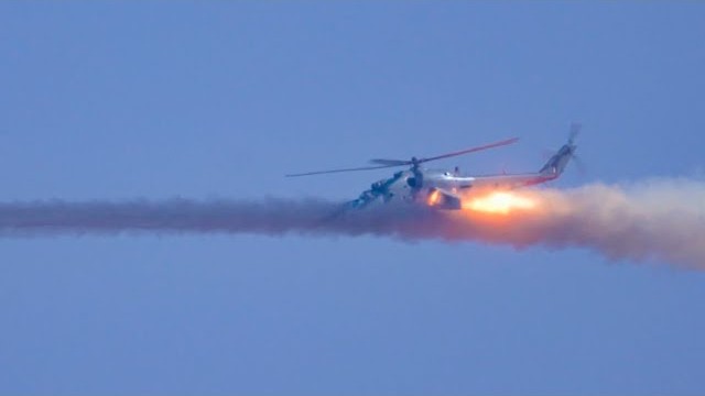 Watch an attack helicopter unleash a devastating rocket barrage mid-flight