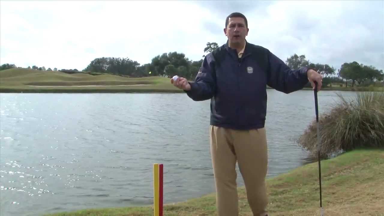 What do red, yellow and white stakes mean on a golf course?