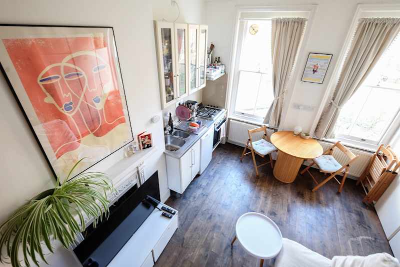 This couple's 250-square-foot studio somehow fits two desks, a dining ...