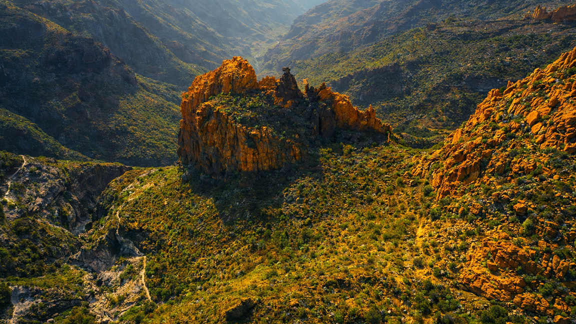 Dramatic rocky outcrop standing above a vast wild landscape