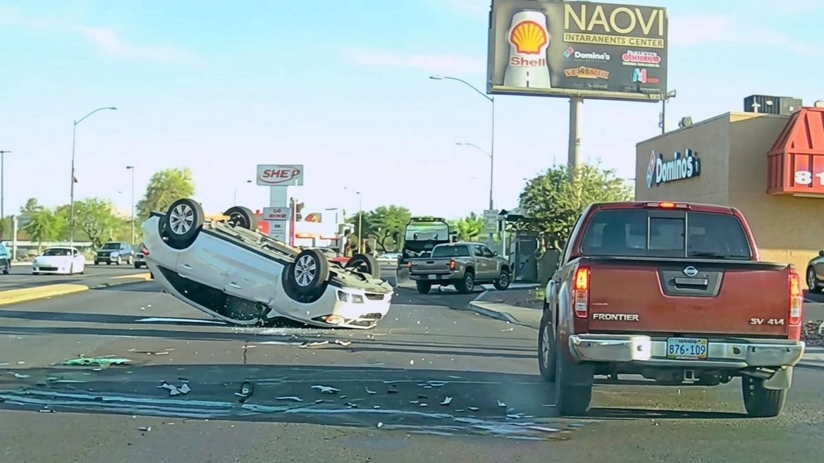 Watch what happens when a car flips over in the middle of the road