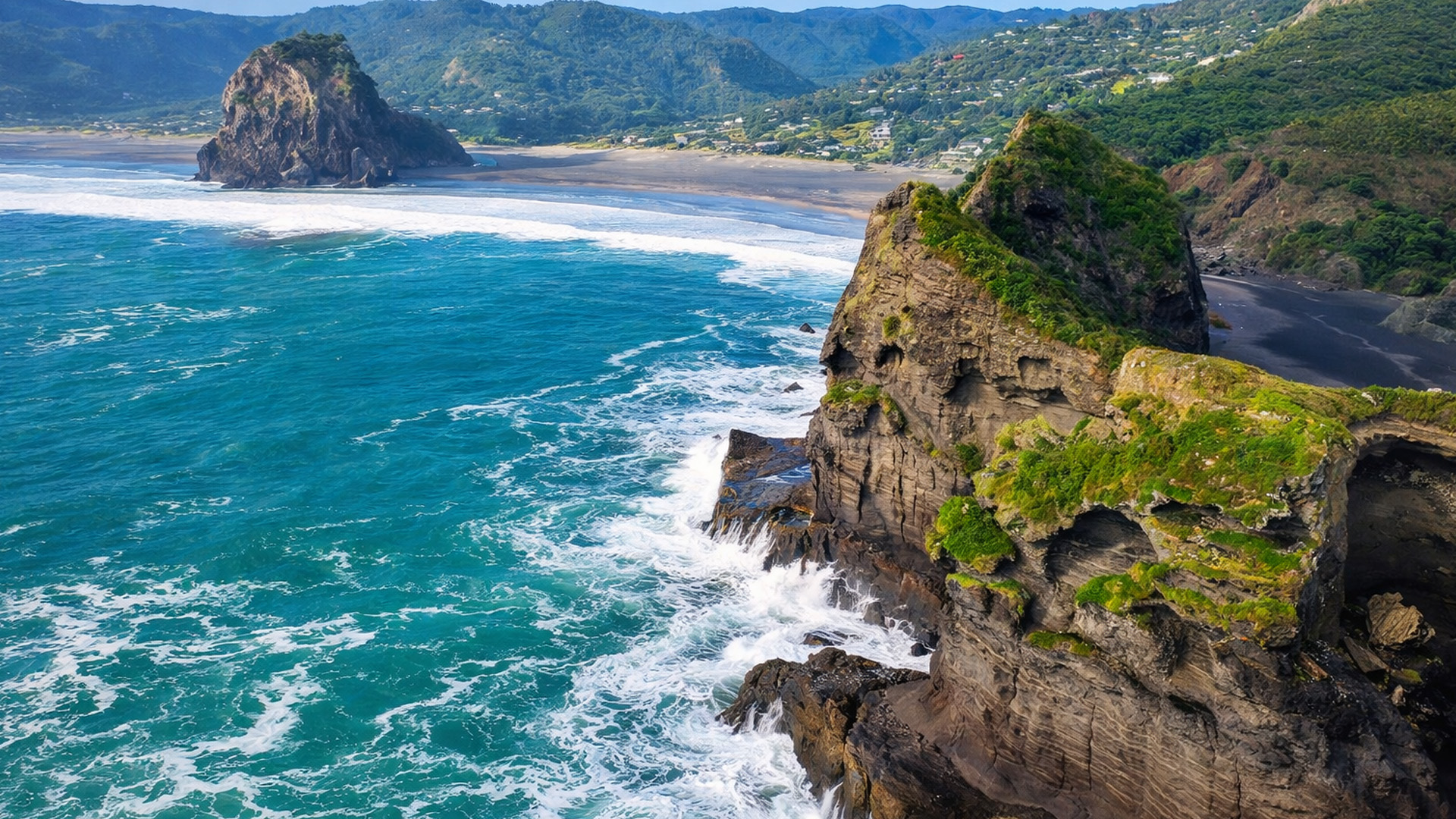 Aerial views of Piha Beach and its rugged coastline