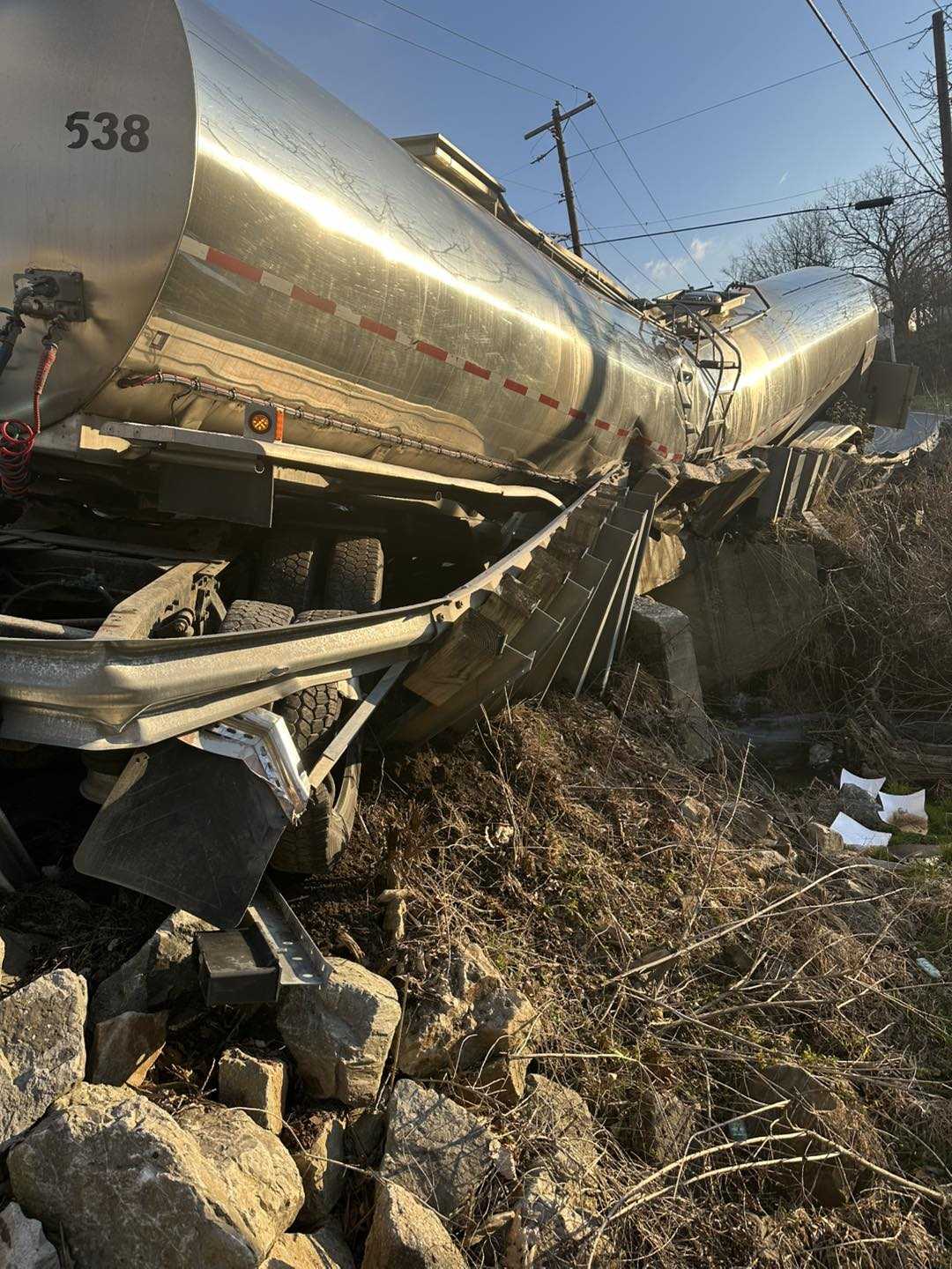 Tanker truck crash shuts down bridge, spills milk into nearby waterway