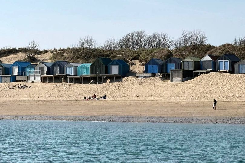 Wales' most expensive beach huts covered in wall of sand