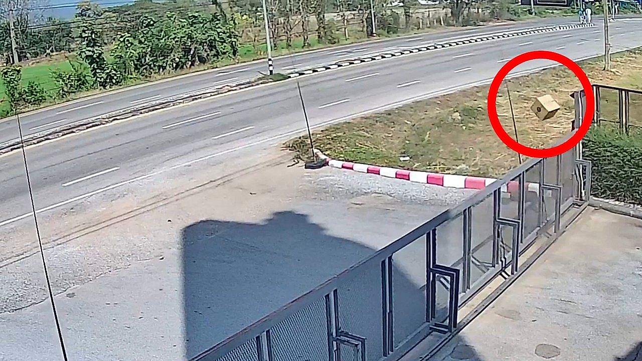 Dust devil snatches parcel from driveway, sends it flying over gate