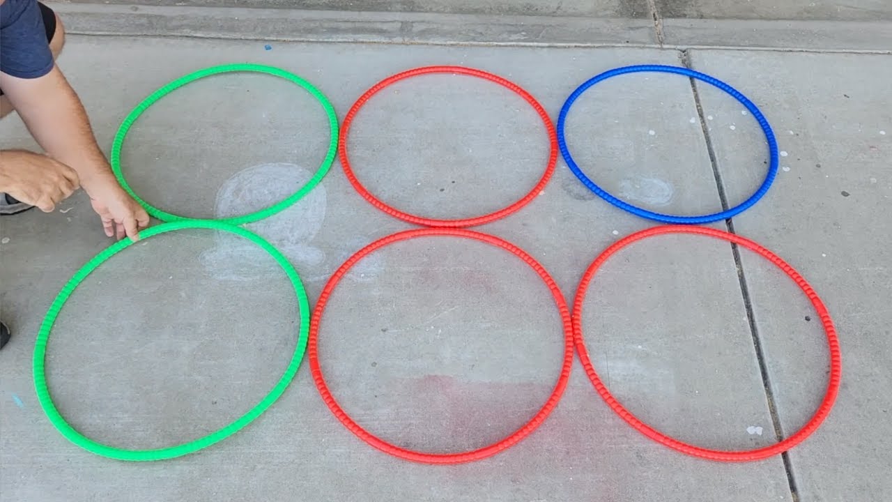 He lays 6 hula hoops on the ground for this brilliant backyard idea!