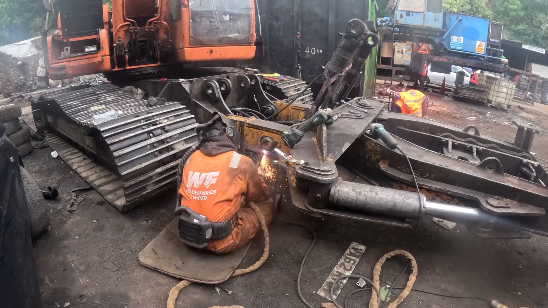 Heavy equipment frame welding in scrap yard