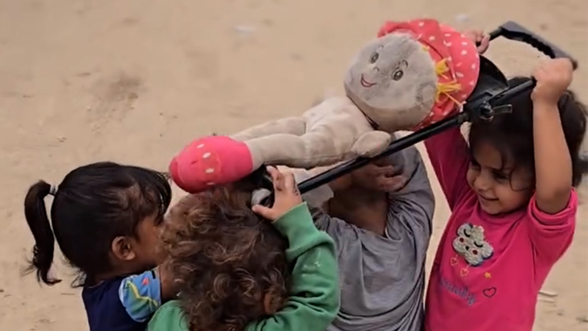 Children in Gaza reenact a funeral procession during play