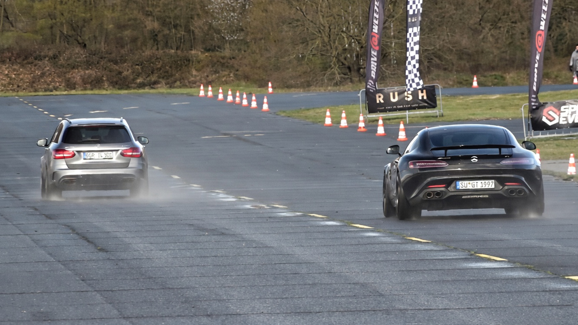 A slippery drag race between AMG C63 and AMG GTS