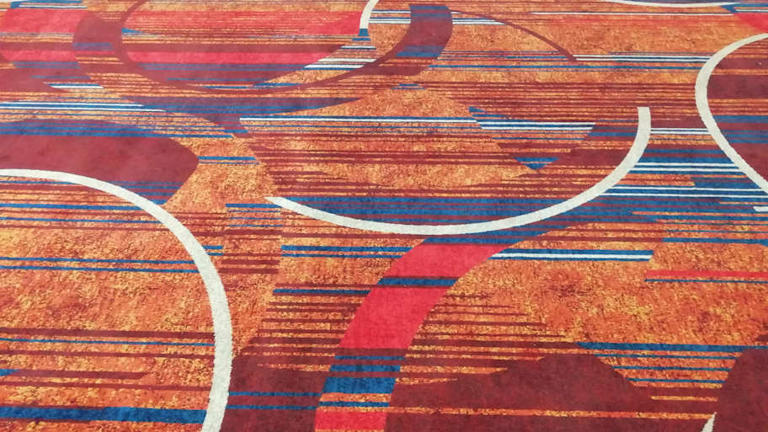 Why are hotel carpets so busy and patterned?