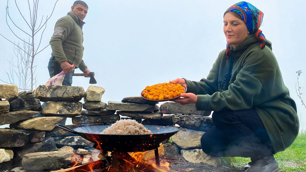 Pilaf cooking slowly in the foggy mountains over an open fire