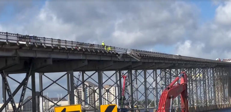 Multi-vehicle crash closes I-10 bridge after bucket truck goes over side