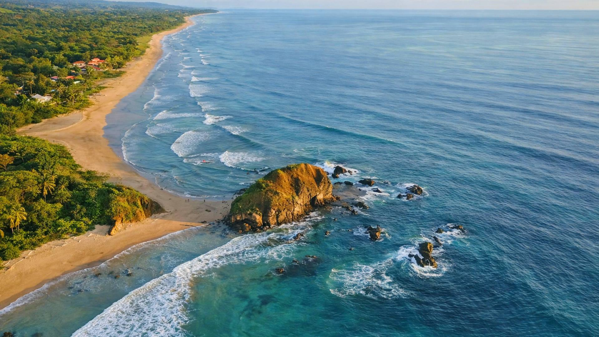 The beach with clear water and cliffs along the shore
