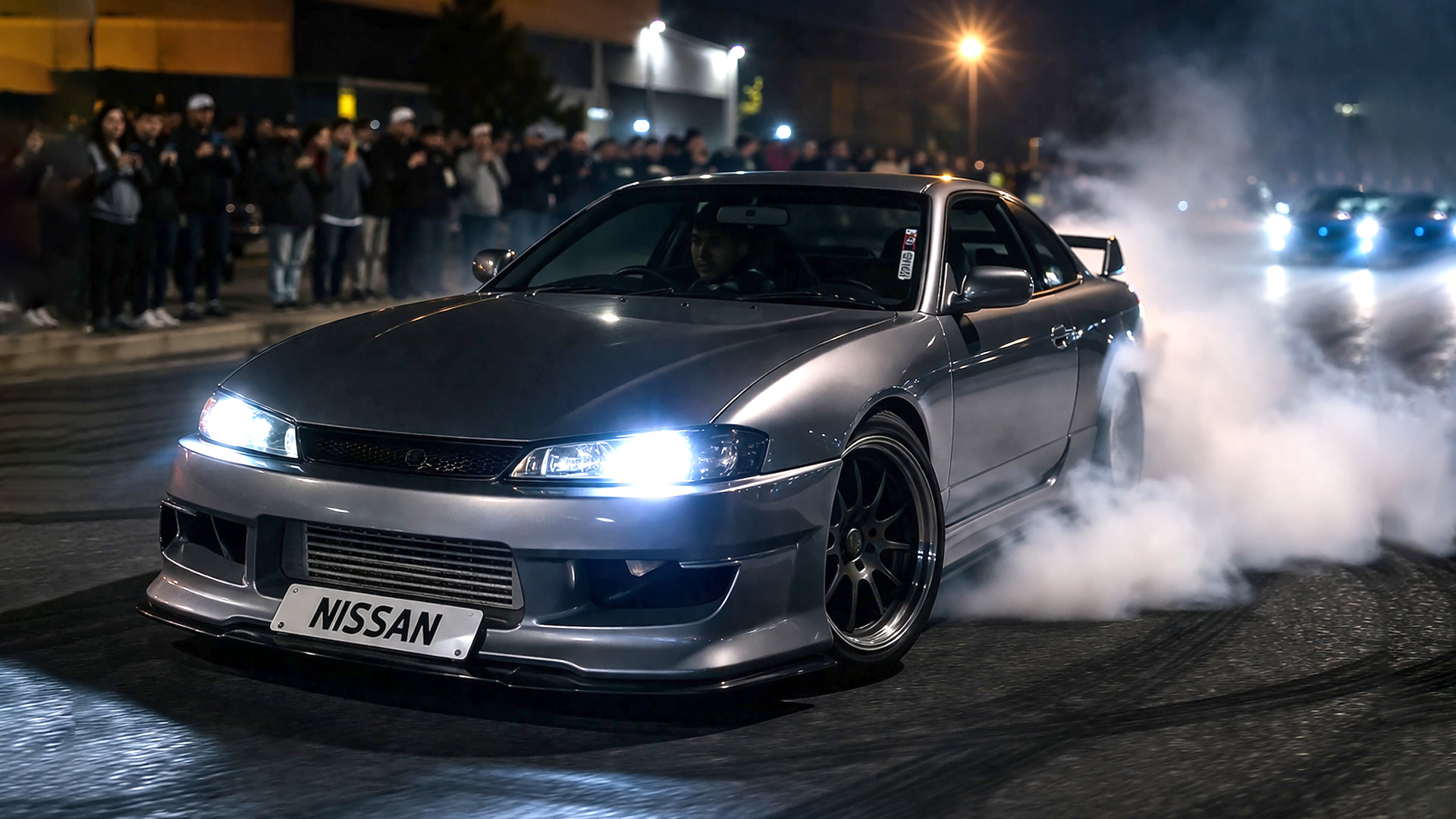 Modified cars show off with burnouts and flames