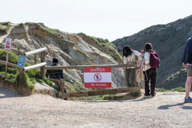 Reckless beachgoers flout warning signs at beauty spot