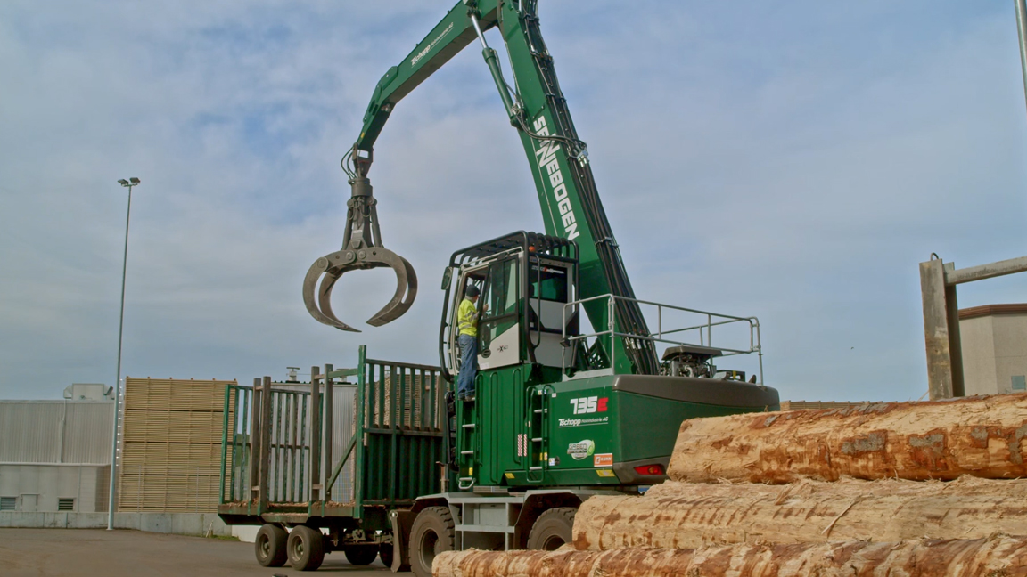Heavy machine effortlessly moving massive timber loads