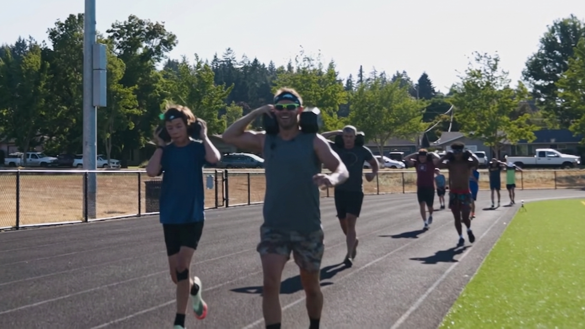 Watch what happens when people run with dumbbells on their back