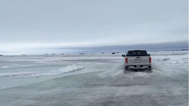 Trucks drive through foot of water atop thawing Minnesota lake in viral ...