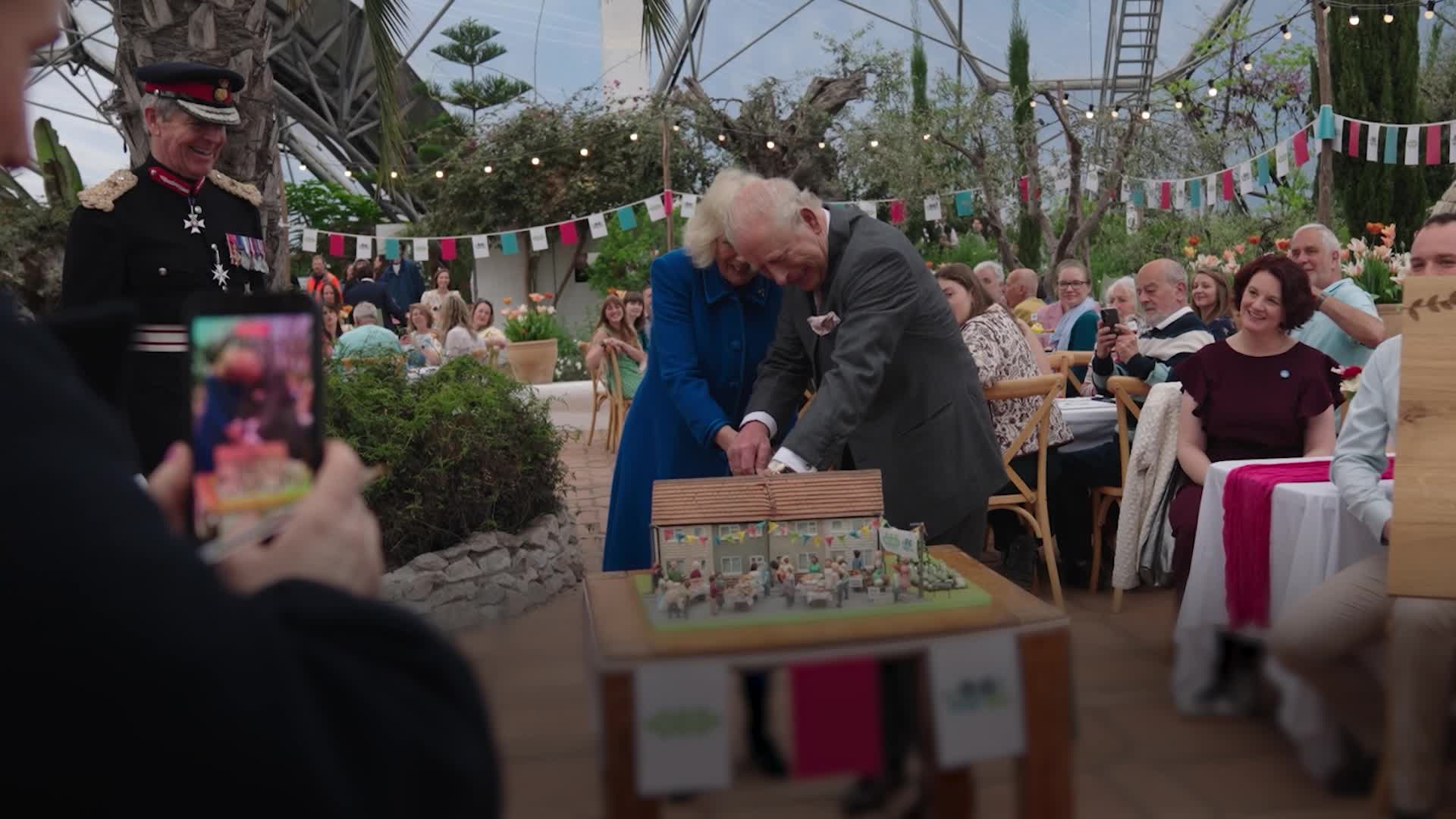 King and Queen share a giggle as they struggle to cut cake with sword