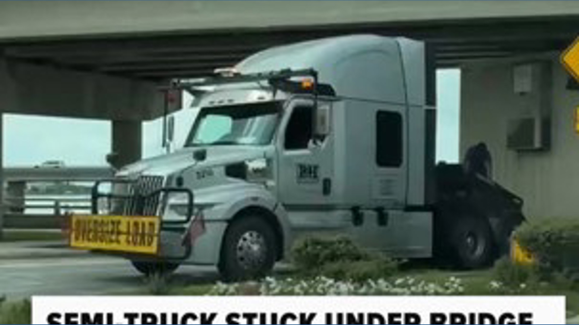 Semi-truck stuck under bridge in Tampa
