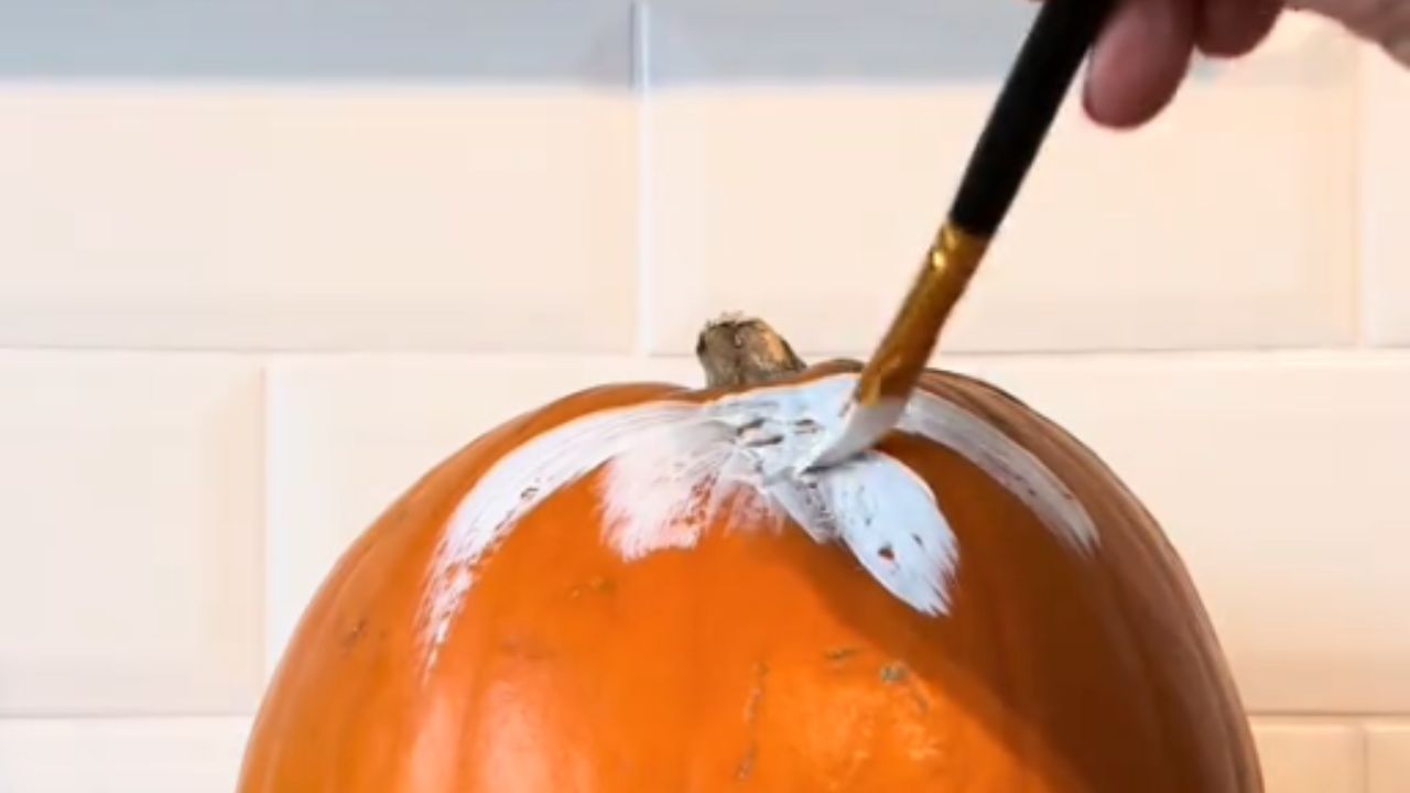 Girl uses pumpkin as canvas for Halloween-themed artwork