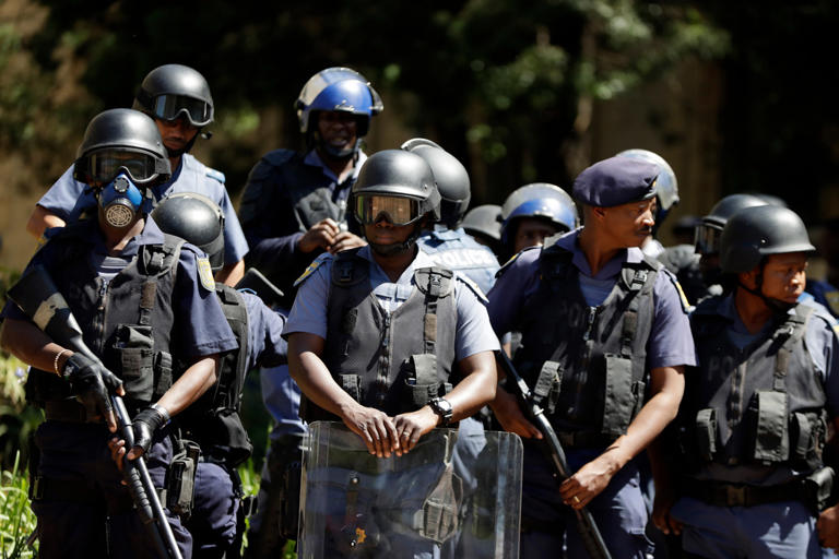 South Africa's top police officer faces charges in a widening ...