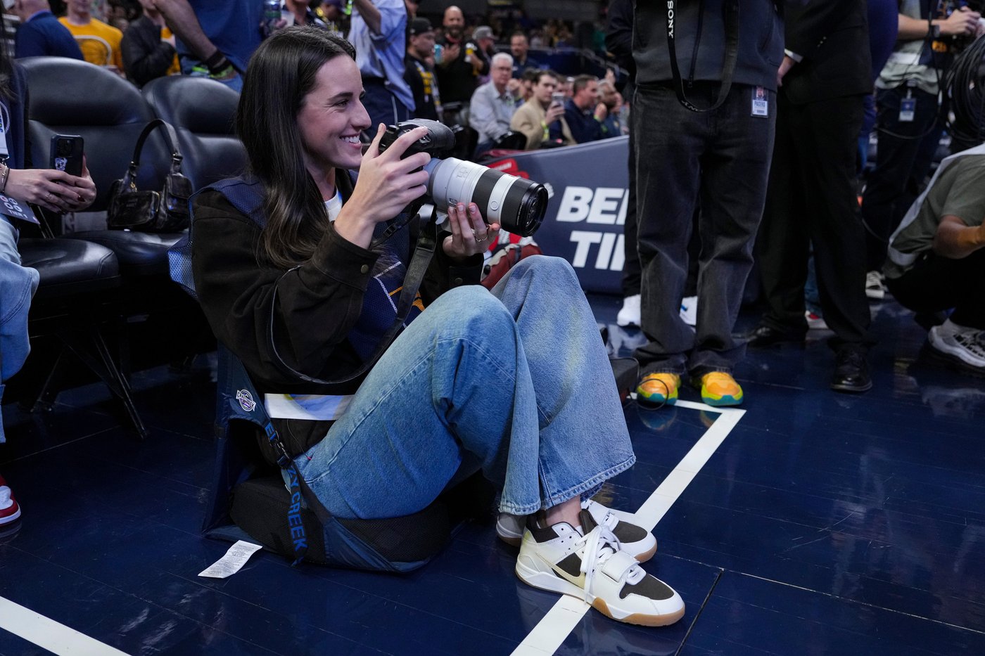 Caitlin Clark works as a photographer for the Indiana Pacers as they ...