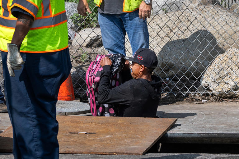 Dramatic moment LA sanitation staff nearly seal homeless people inside ...