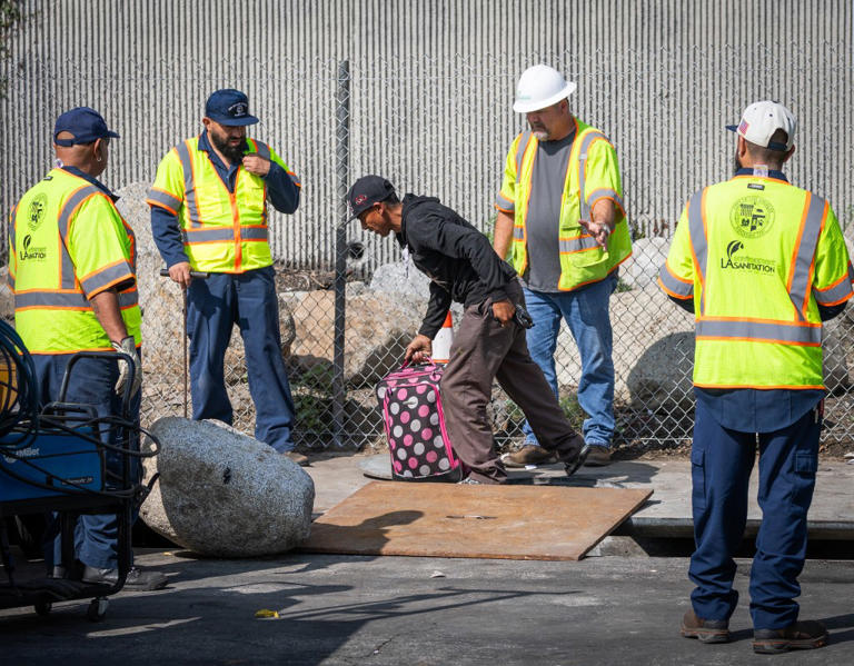 Dramatic moment LA sanitation staff nearly seal homeless people inside ...