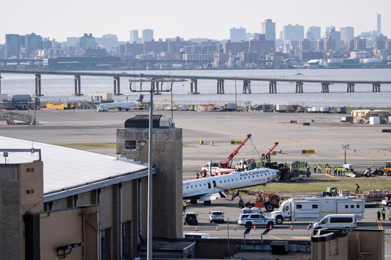 Mangled plane in LaGuardia crash is towed from runway as most injured ...
