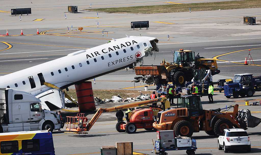 Mangled plane in LaGuardia crash is towed from runway as most injured ...