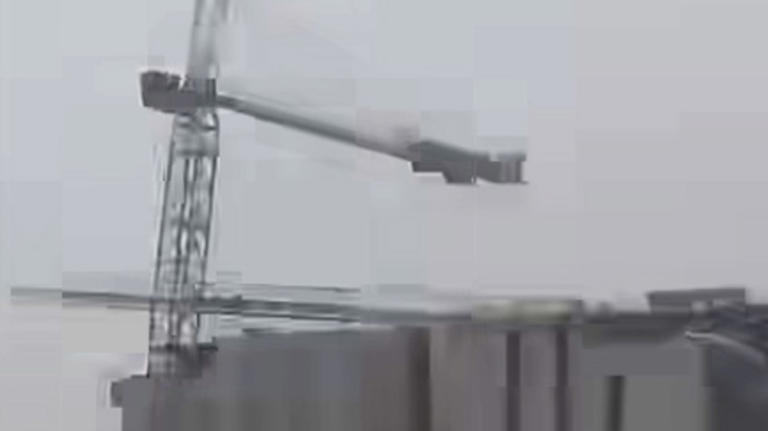 Insane moment crane topples from building