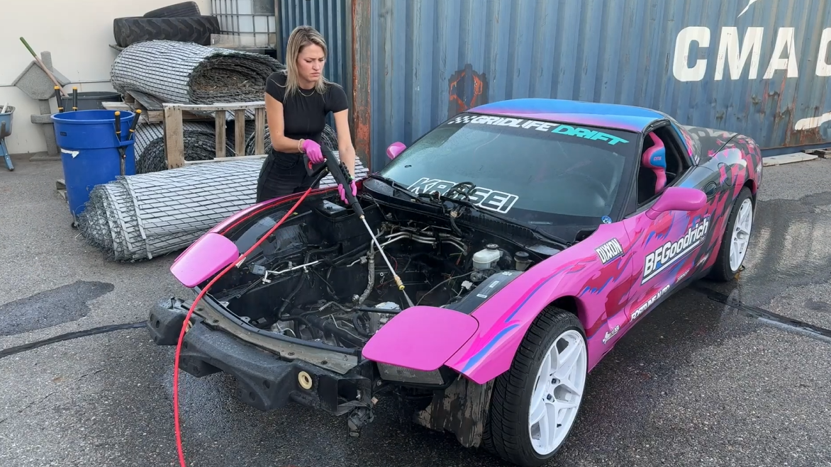 Pressure washing the engine bay of a sports car